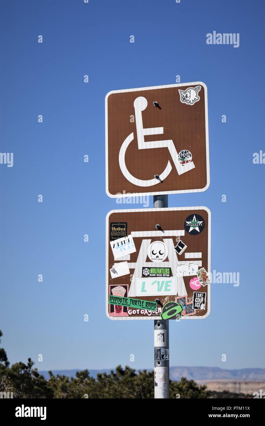 Defaced Street signs for handicapped and informational concepts with ...