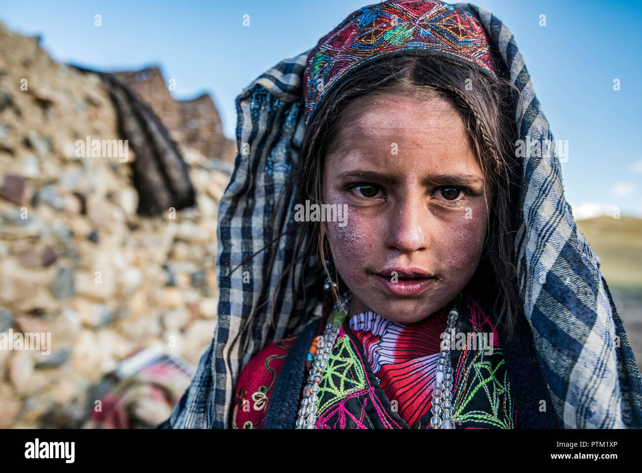A young Wakhi girl dressed in traditional clothes in the Wakhan ...