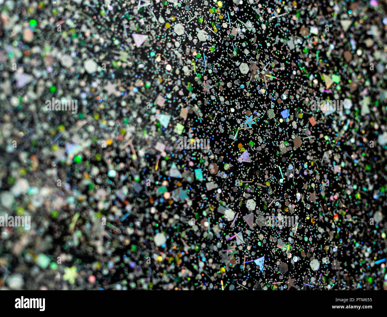 Holographic glitter on black background. Abstract art multicolor ...