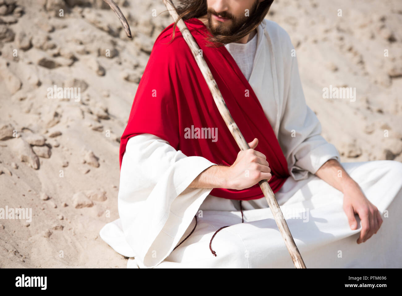 cropped image of Jesus in robe, red sash and crown of thorns sitting in ...