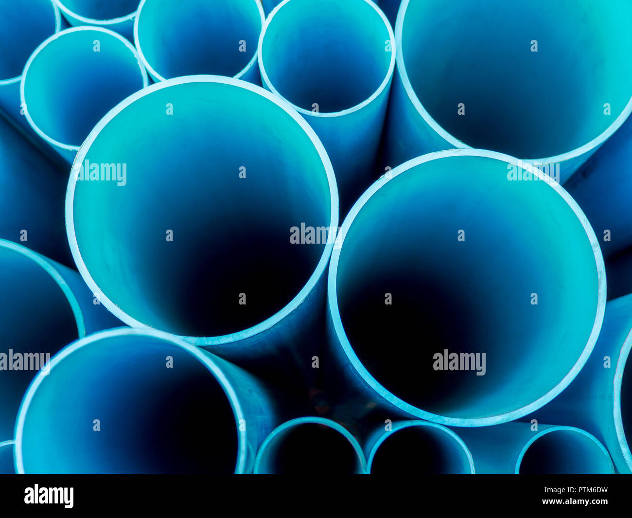 Close-up tubes PVC pipes stacked in warehouse. Blue PVC pipes ...