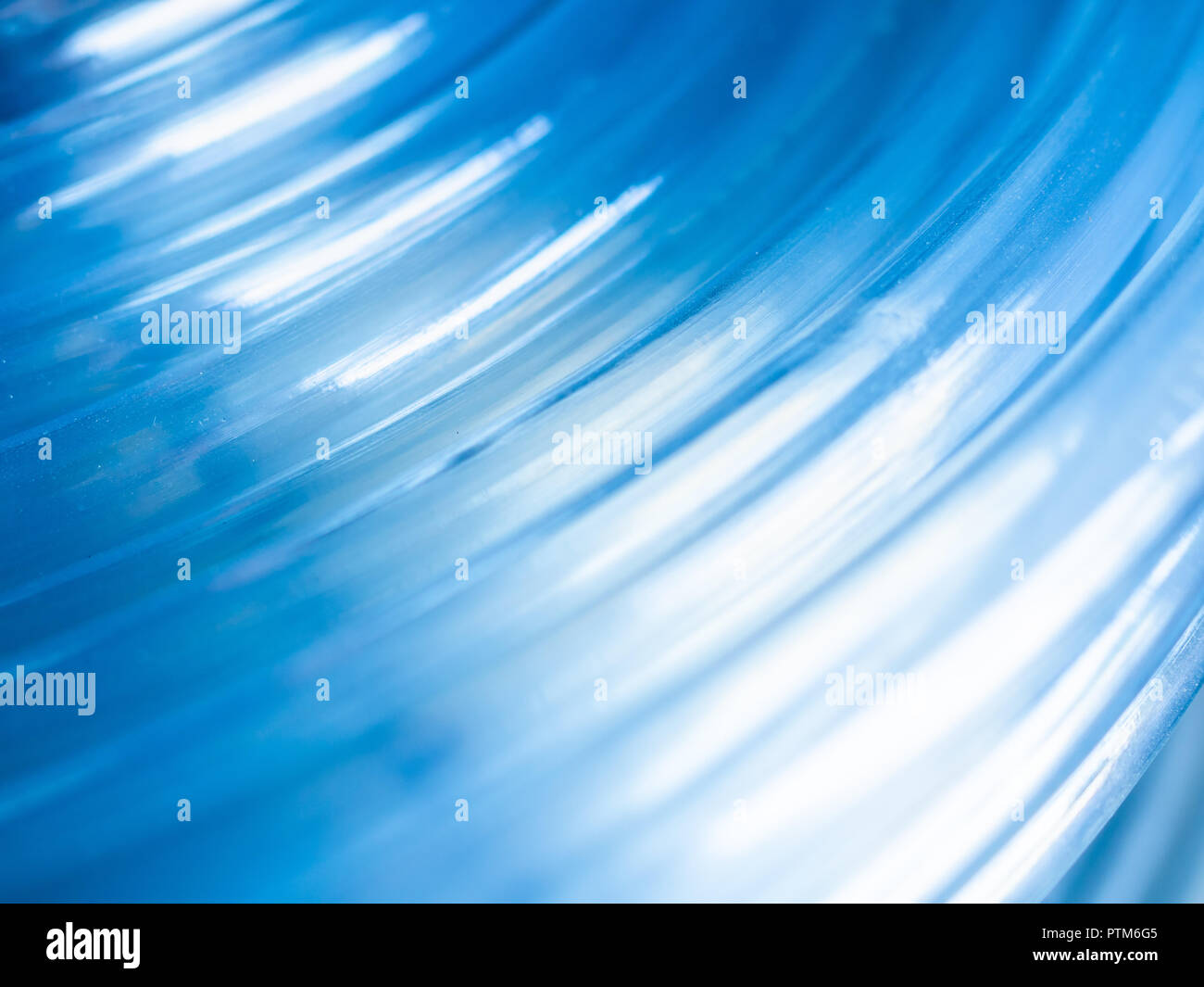 Transparent plastic water hose. Abstarct blue curve line background ...