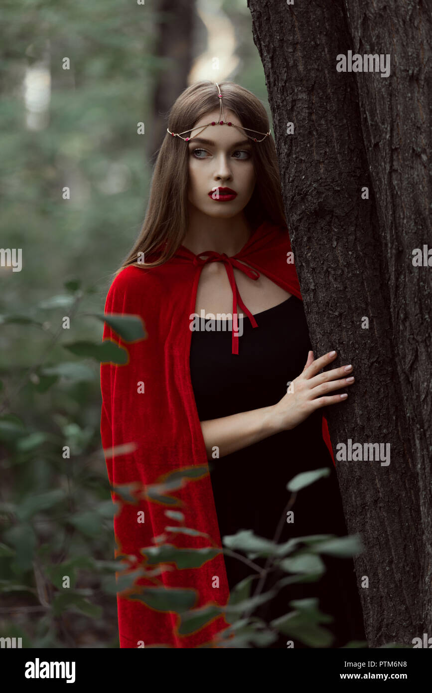beautiful mystic girl in red cloak and elegant wreath in forest Stock ...