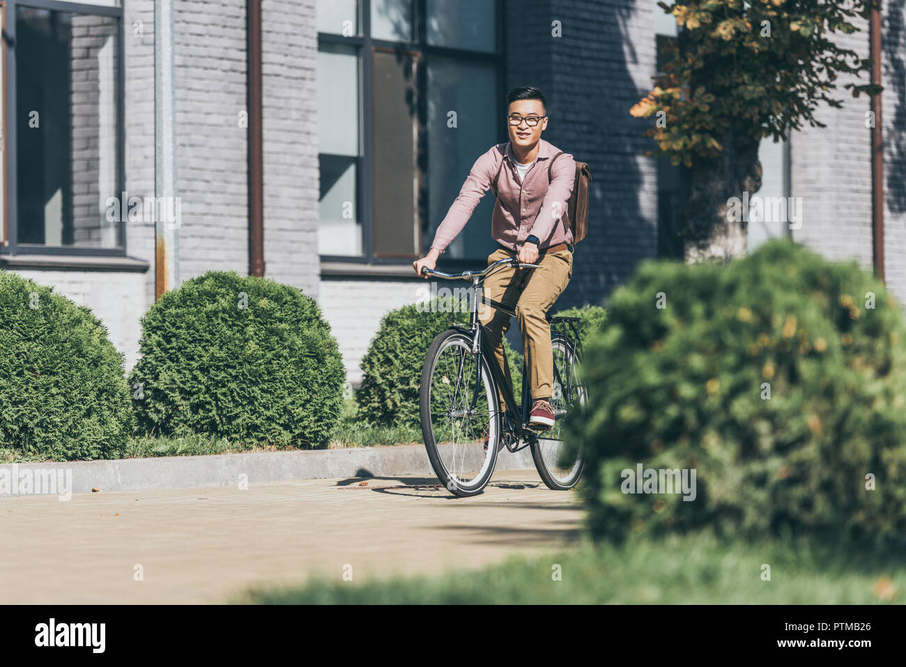 Asian man riding bicycle hi-res stock photography and images - Alamy