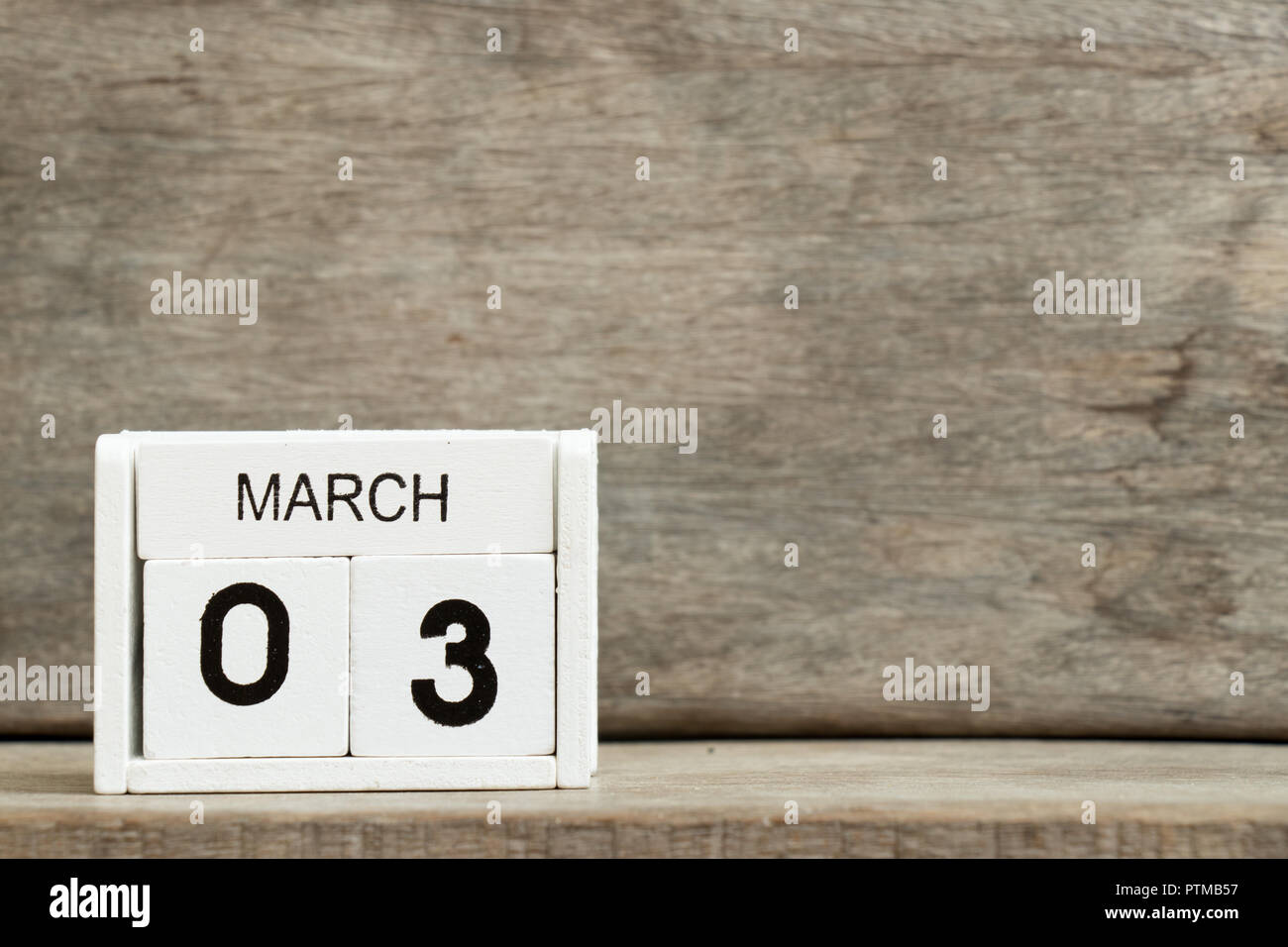 White block calendar present date 3 and month March on wood background ...
