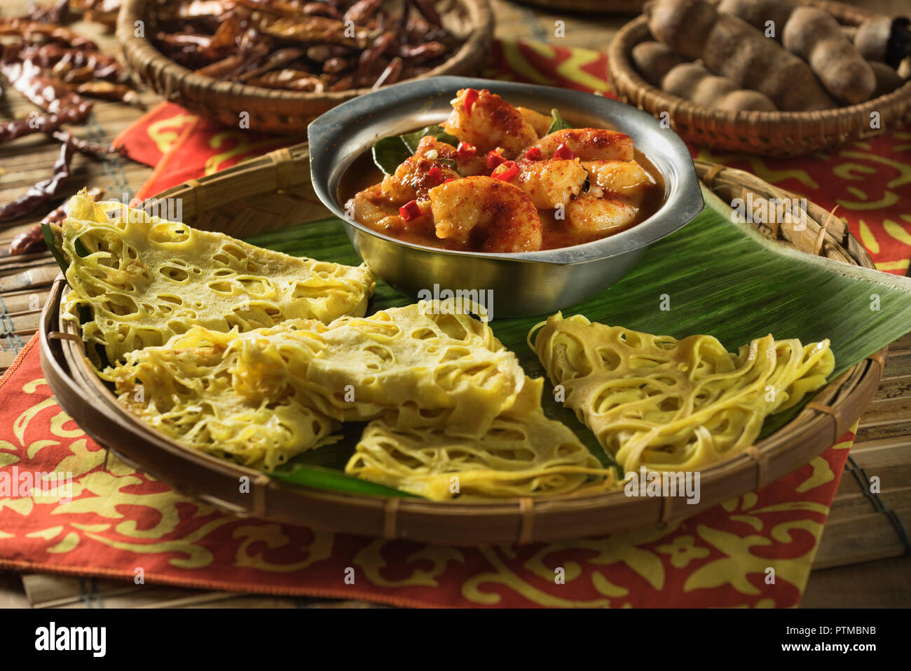 Sambal udang with roti jala. Spicy prawns with lacy pancakes. Malaysia ...