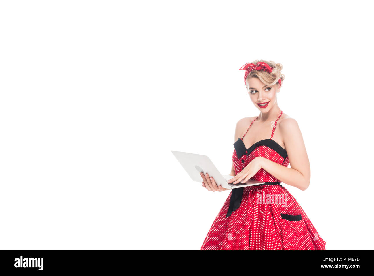portrait of beautiful woman in pin up style clothing with laptop ...