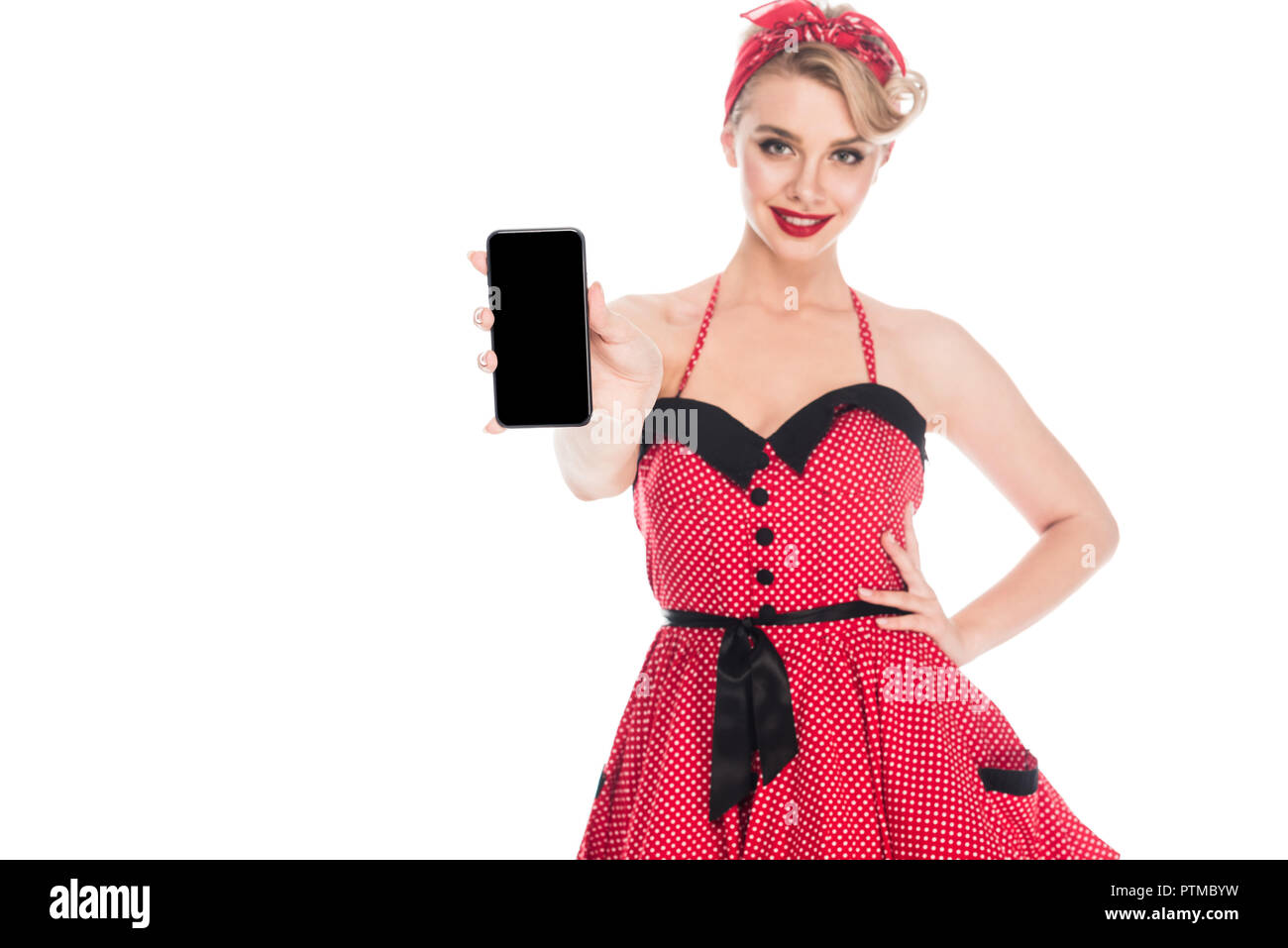 portrait of beautiful pin up woman showing smartphone with blank screen ...