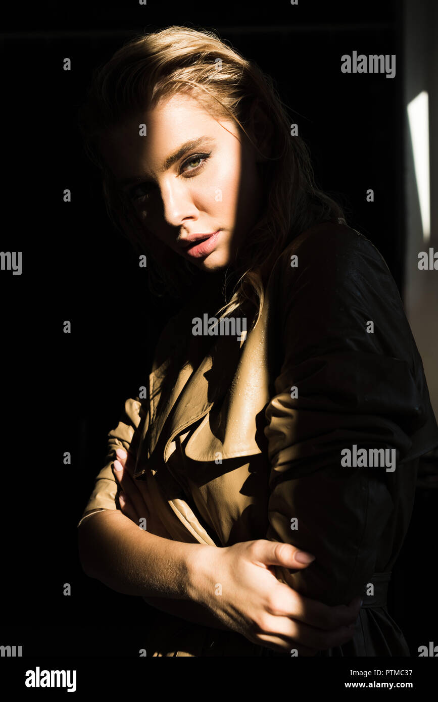 side view of beautiful and stylish model looking at camera Stock Photo ...