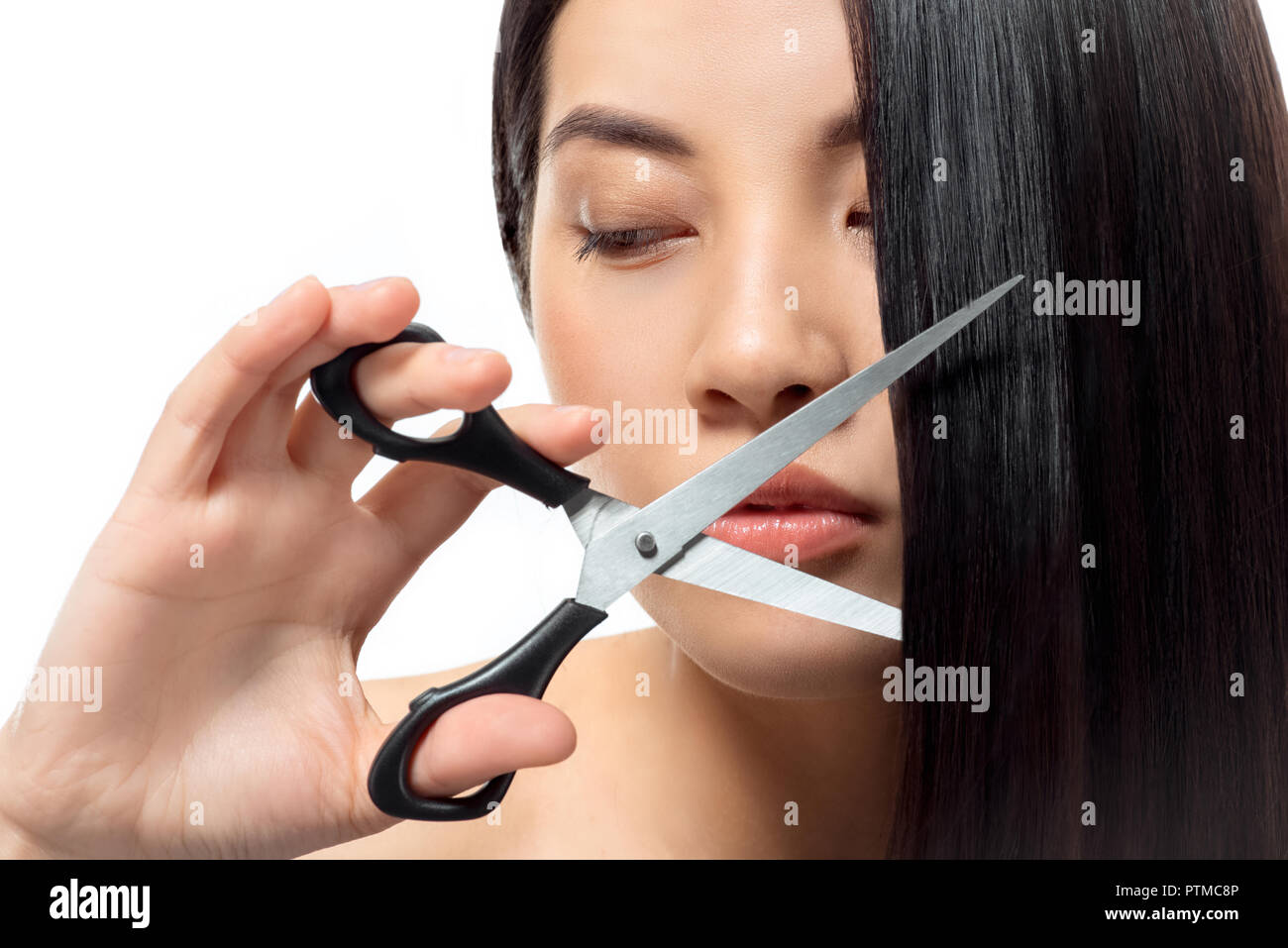 portrait of asian woman with scissors isolated on white, damaged hair ...