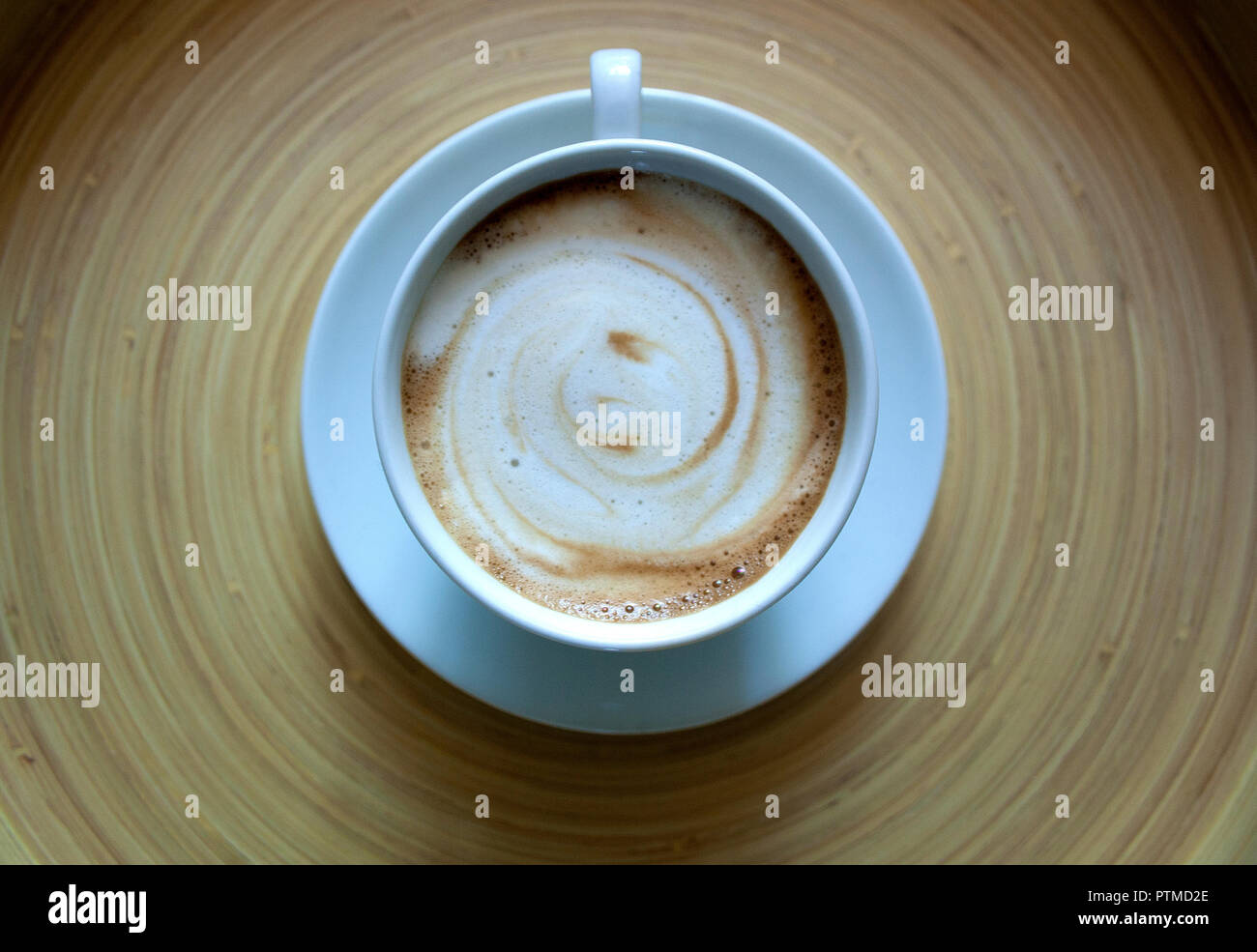 A coffee cup on a wooden background with circular design Stock Photo ...