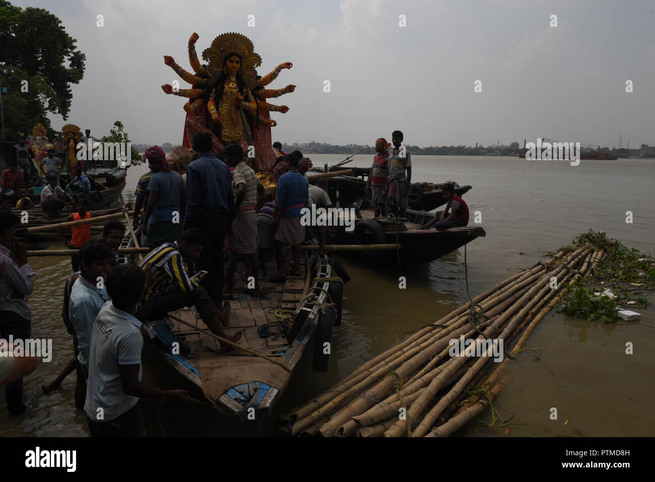 Hindu people are carrying the idol of Devi Durga over River Ganges on ...