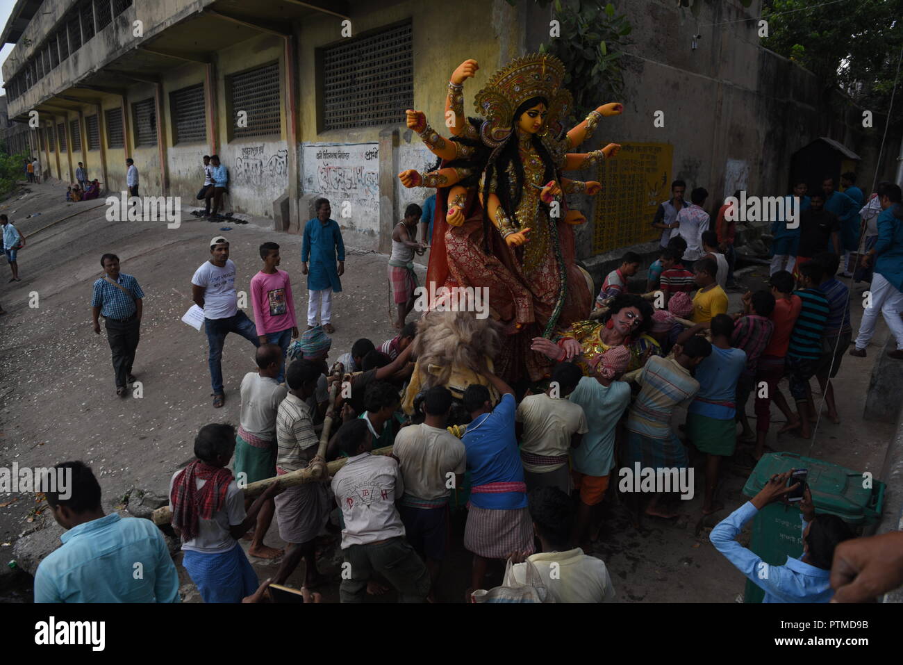 Hindu people are carrying the idol of Devi Durga over River Ganges on ...