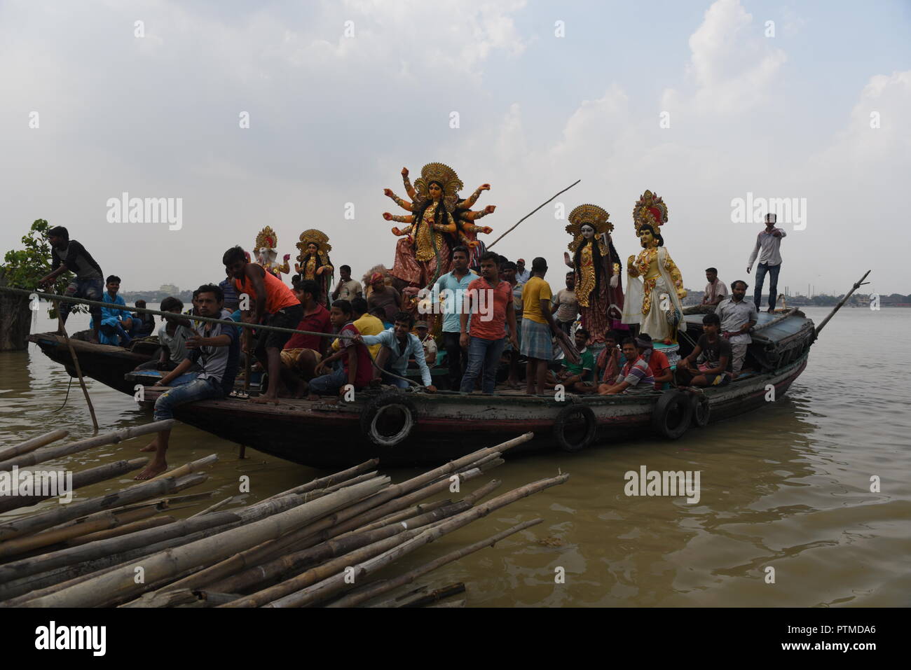 Hindu people are carrying the idol of Devi Durga over River Ganges on ...