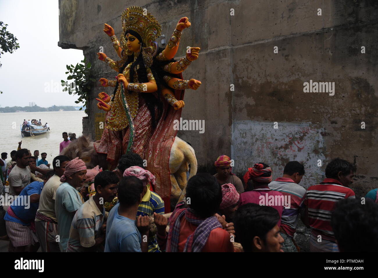 Hindu people are carrying the idol of Devi Durga over River Ganges on ...