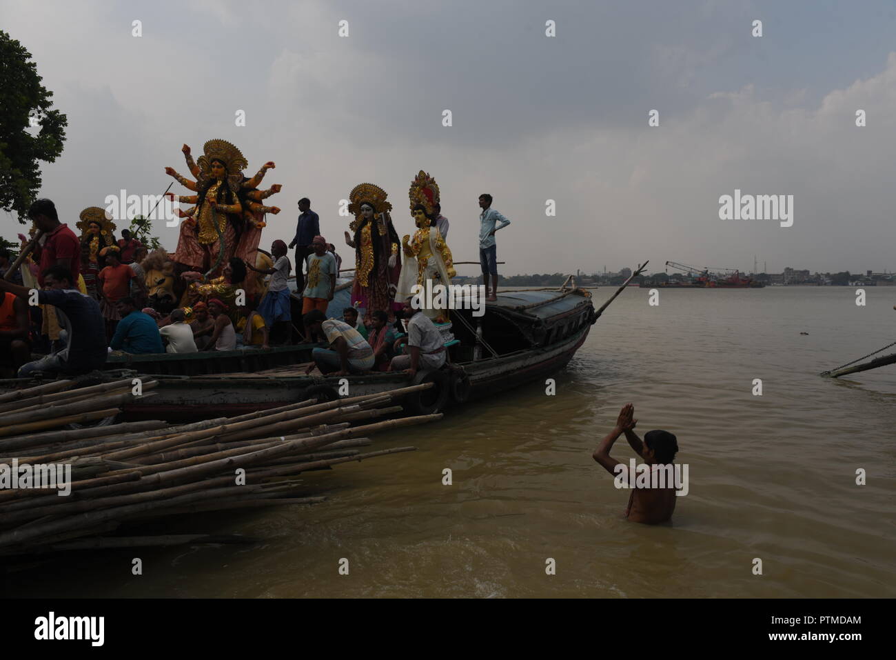 Hindu people are carrying the idol of Devi Durga over River Ganges on ...