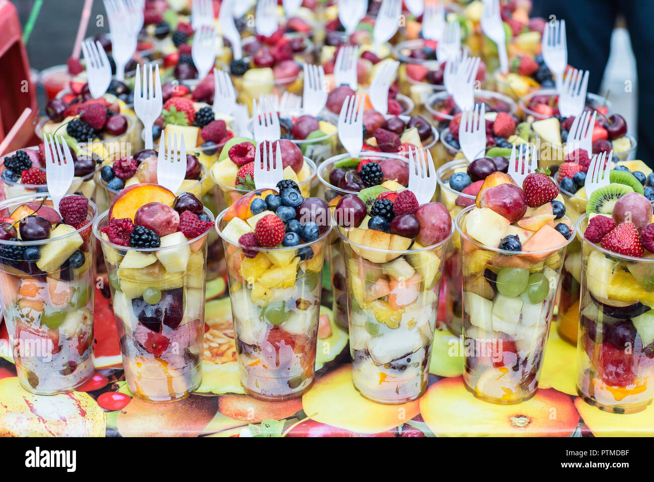 Take away salad of healthy sliced organic berries and fruits at a ...