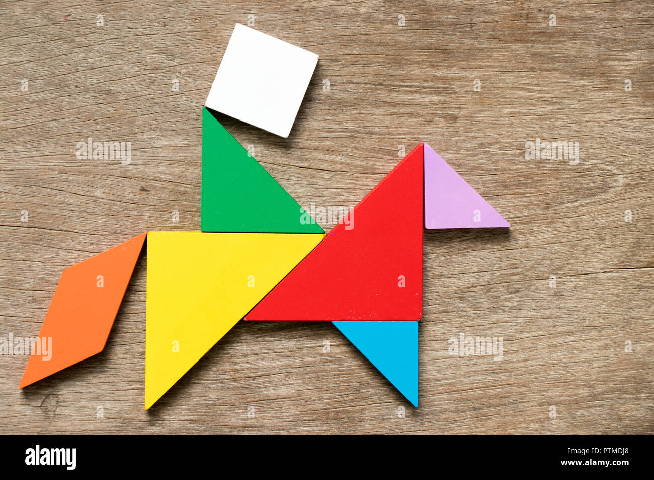 Colorful tangram puzzle in man ride on the horse shape on wood ...