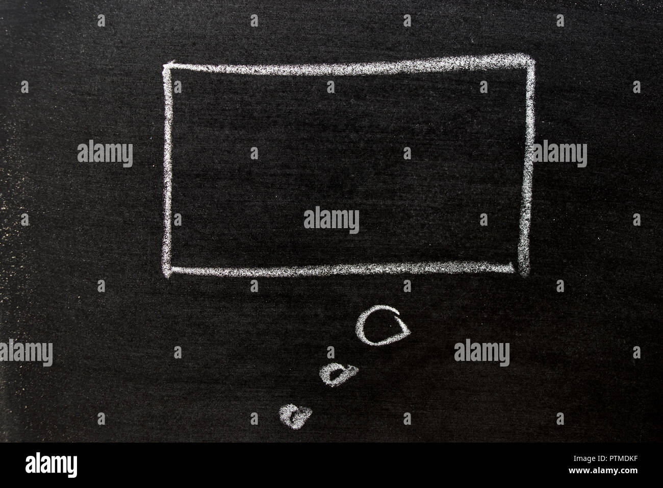 White color chalk hand drawing as speech bubble shape on black board ...
