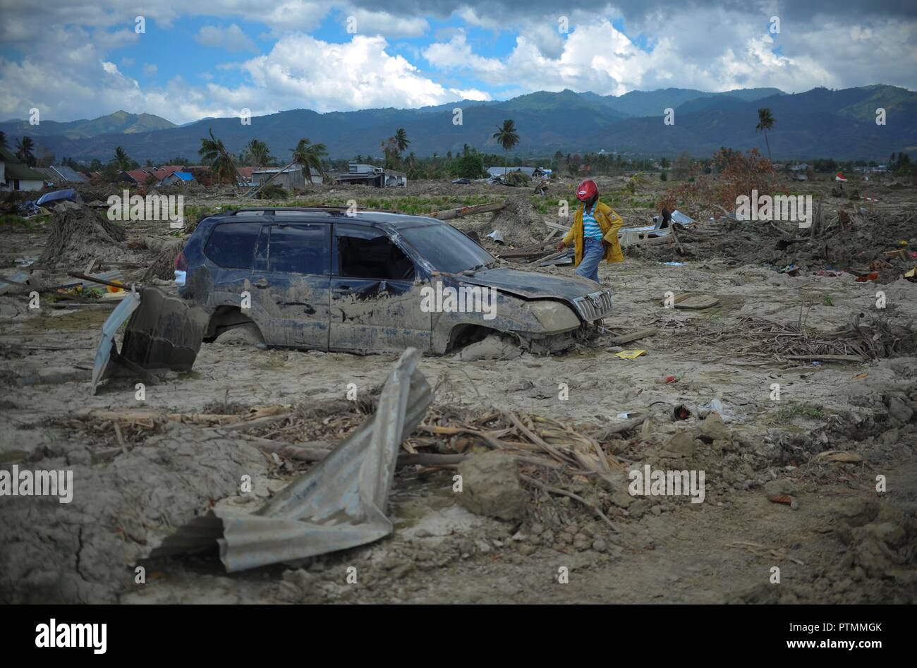 Poso, Indonesia. 9th Oct, 2018. A person walks on dried mud in Poso ...