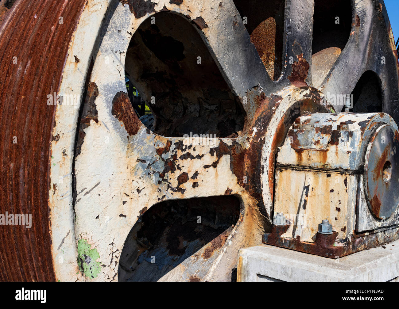 Rusty weathered steel cable spool winch with white paint Stock Photo ...