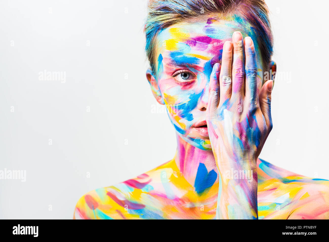 attractive girl with colorful bright body art covering eye isolated on ...
