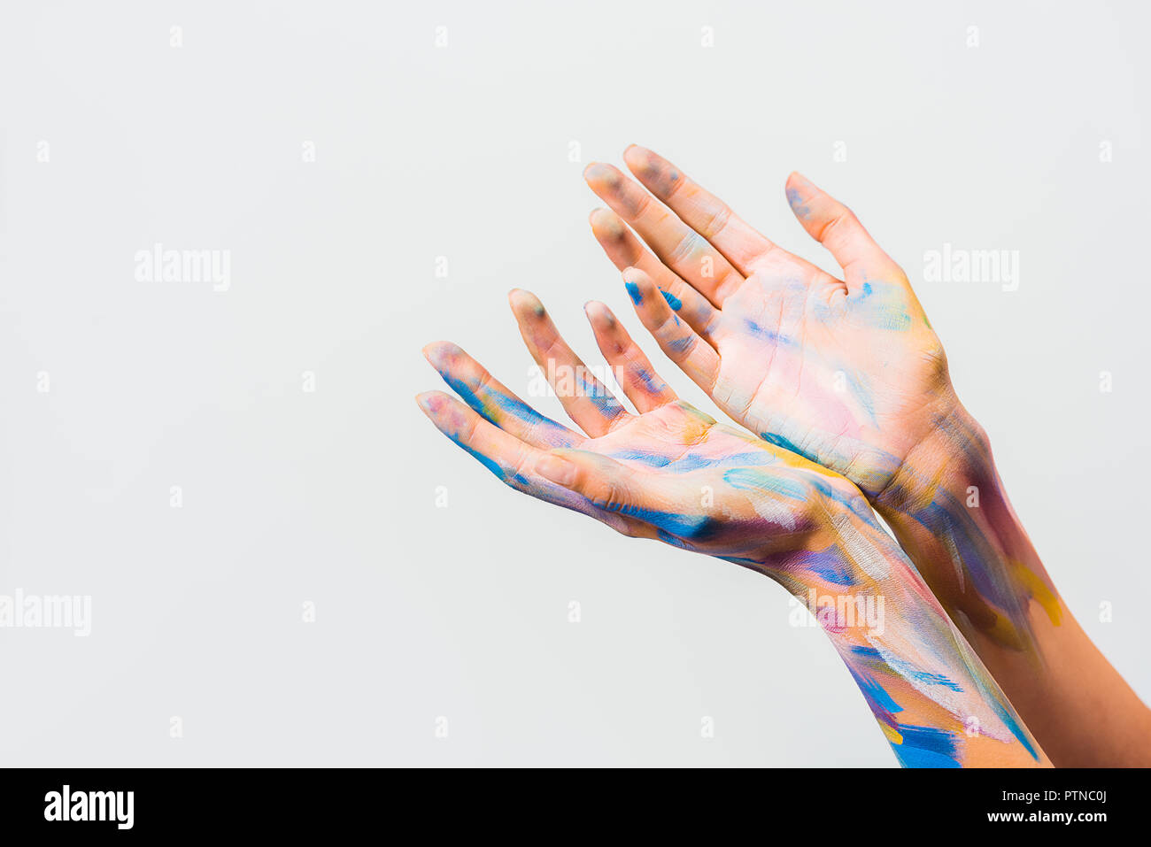 cropped image of girl with colorful bright body art showing hands ...