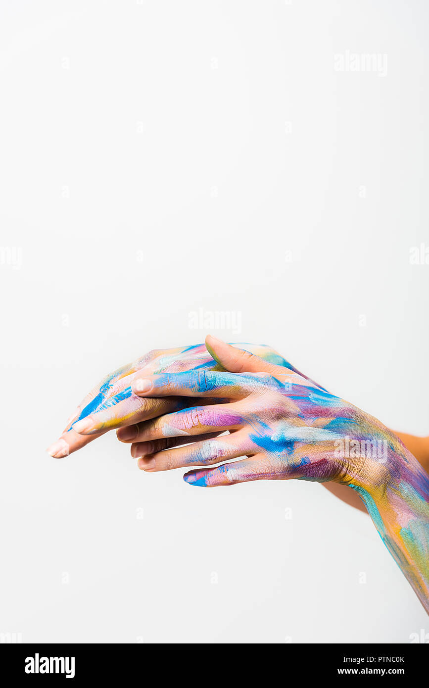 cropped image of girl with colorful bright body art touching hands ...