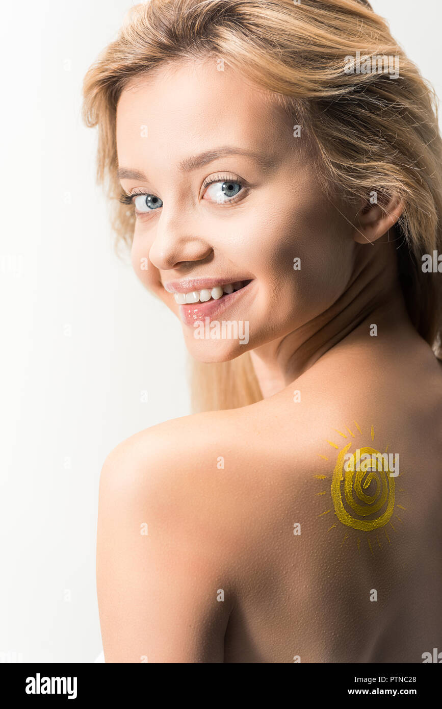 beautiful girl with painted yellow sun on shoulder looking at camera ...