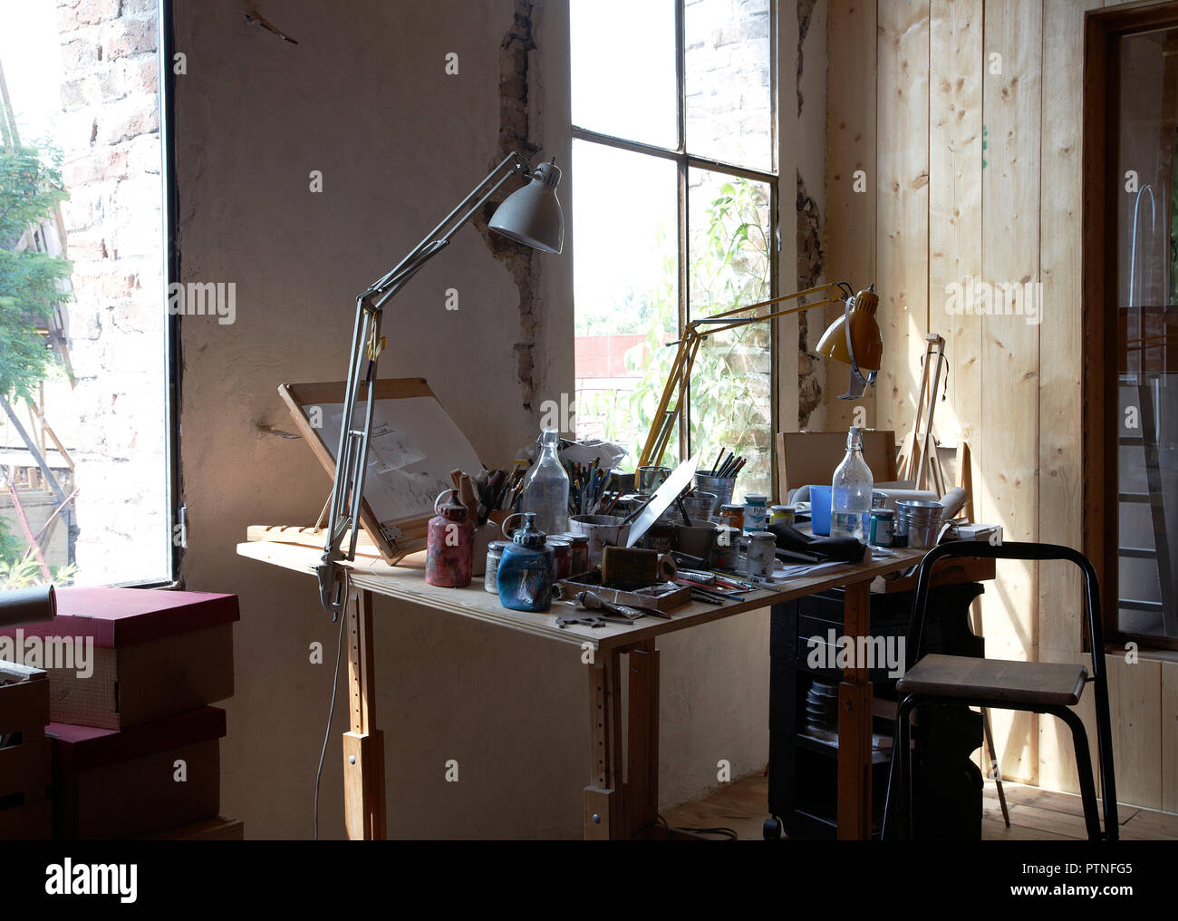 Messy studio of an artist, table with several objects, lamps Stock ...