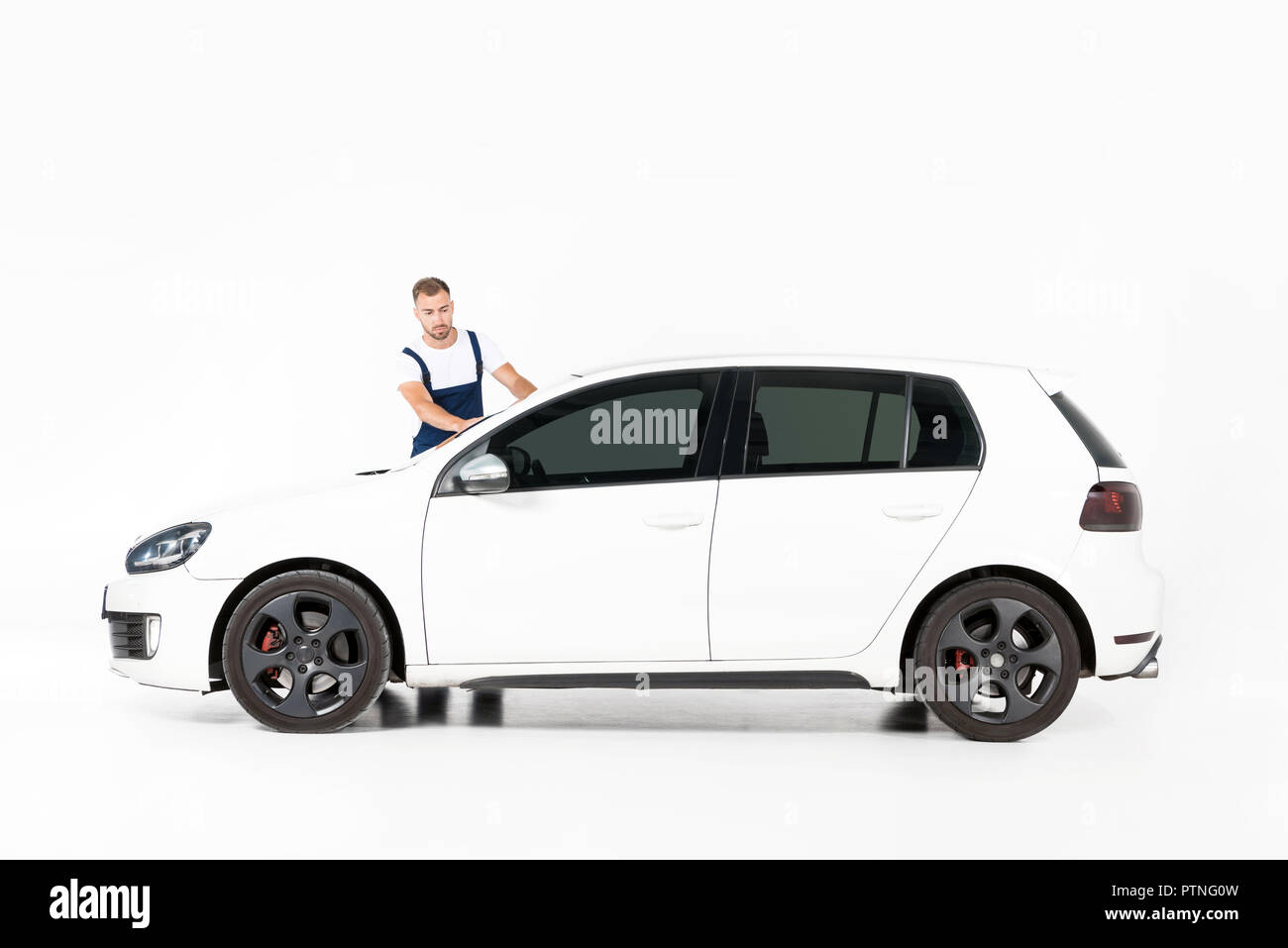 Mechanic working on car Cut Out Stock Images & Pictures - Alamy