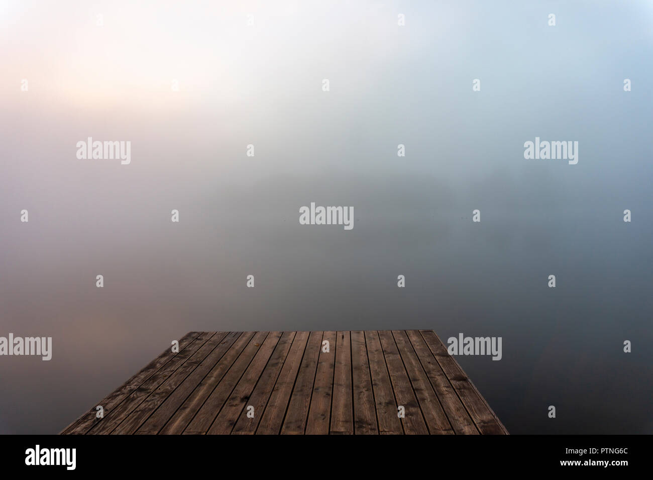 Landscape of dock in fog, a wooden dock at the lake showing morning ...