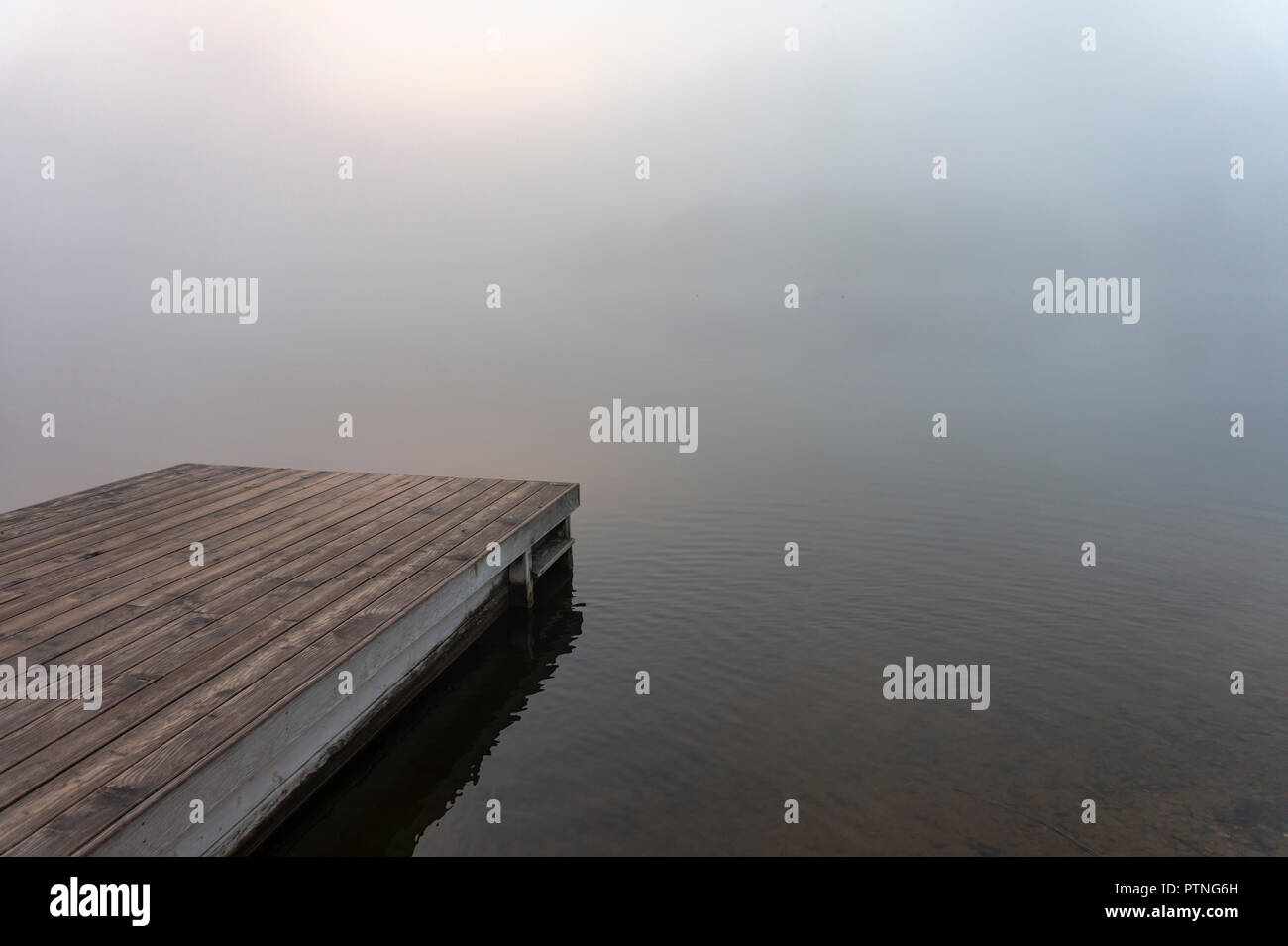 Landscape of dock in fog, a wooden dock at the lake showing morning ...