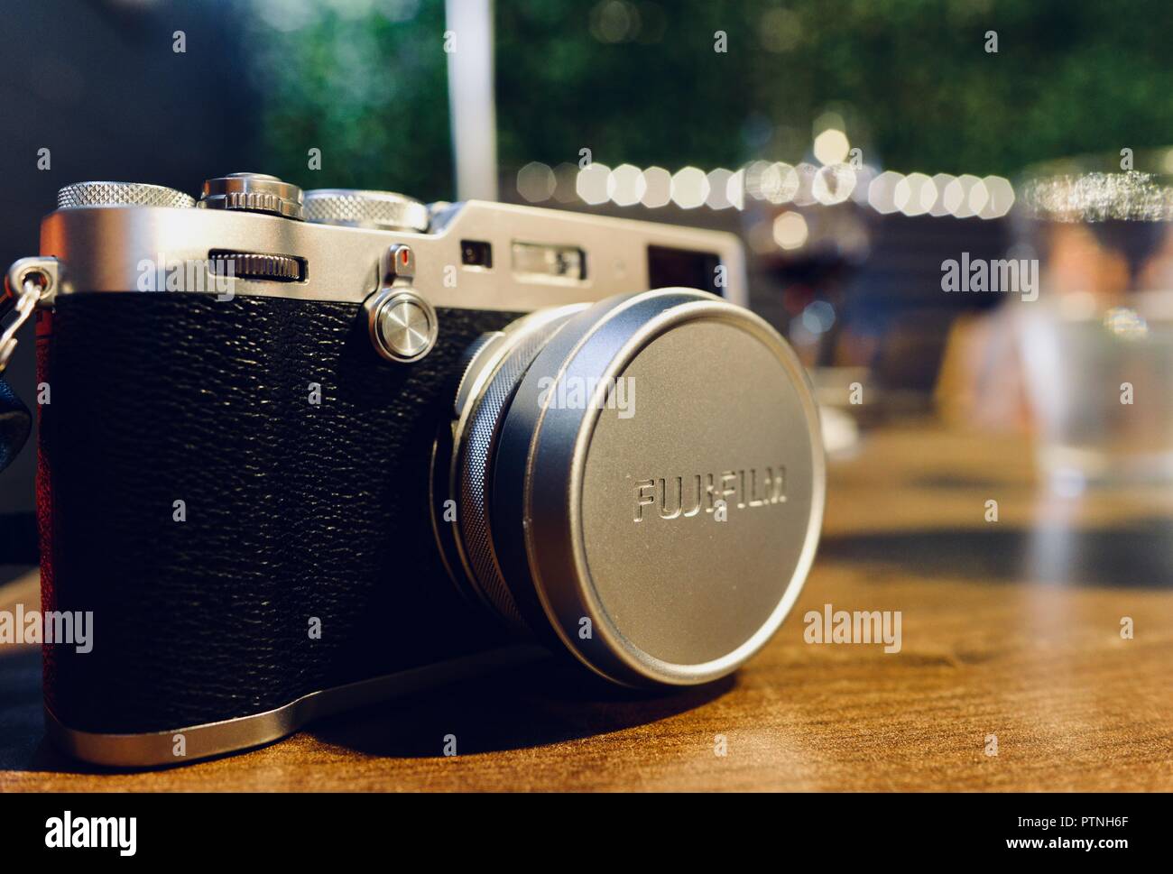 Fujifilm x100f camera on a table at night Stock Photo - Alamy
