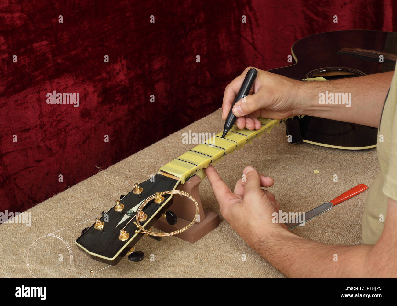 Musical instrument guitar repair and service - Worker preparation of ...