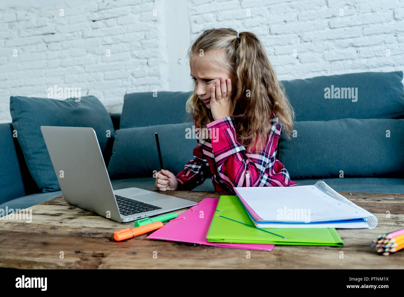 Cute elementary student feeling sad and confusing while doing difficult ...