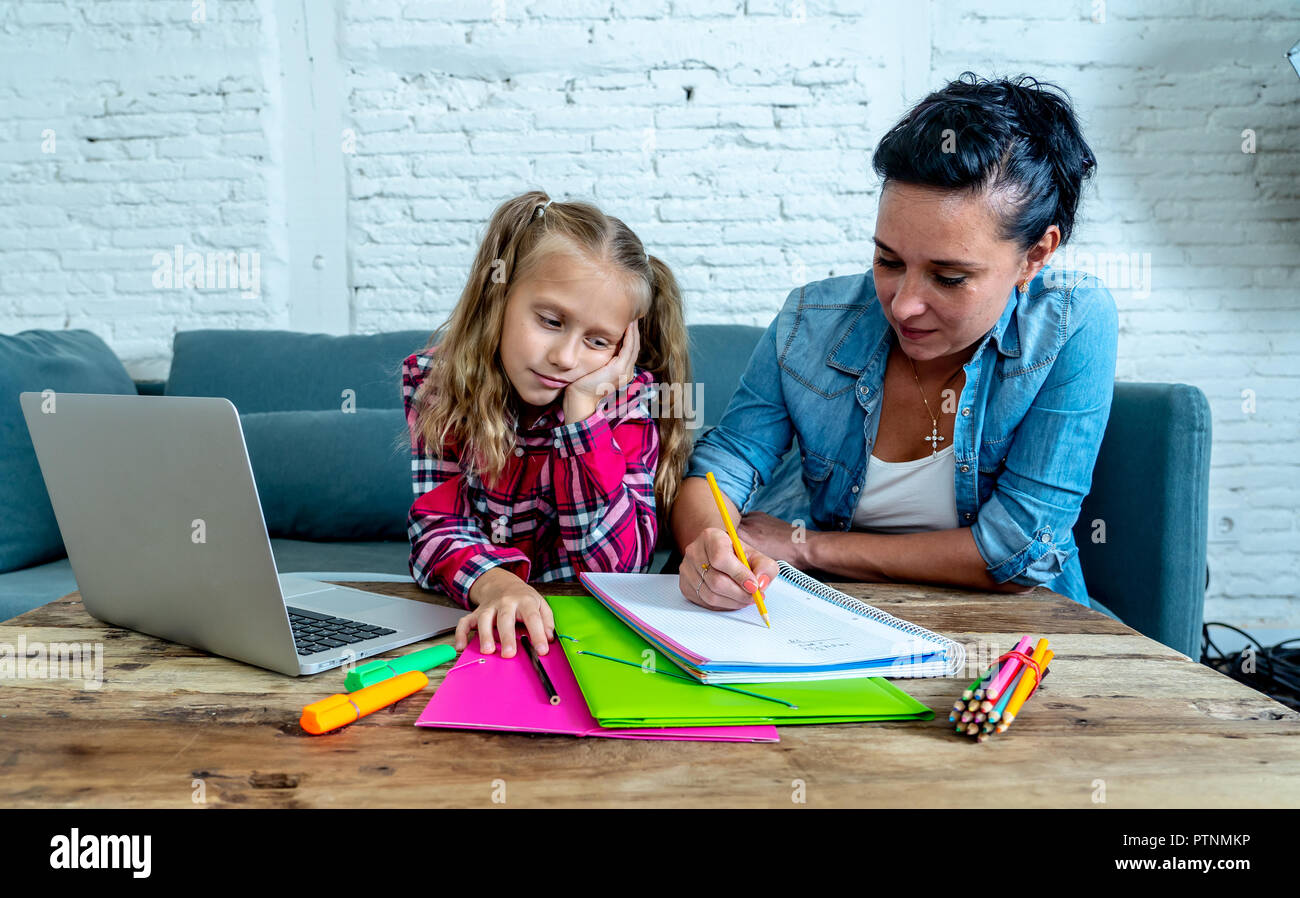 Mother becoming frustrated with daughter whilst doing homework sitting ...