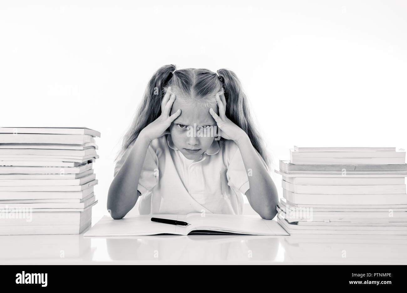Sad and tired cute schoolgirl with blond hair sitting in stress doing ...
