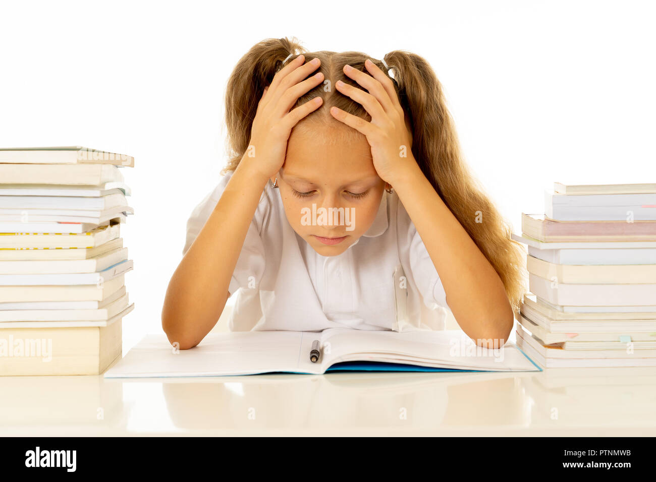 Sad and tired cute schoolgirl with blond hair sitting in stress doing ...