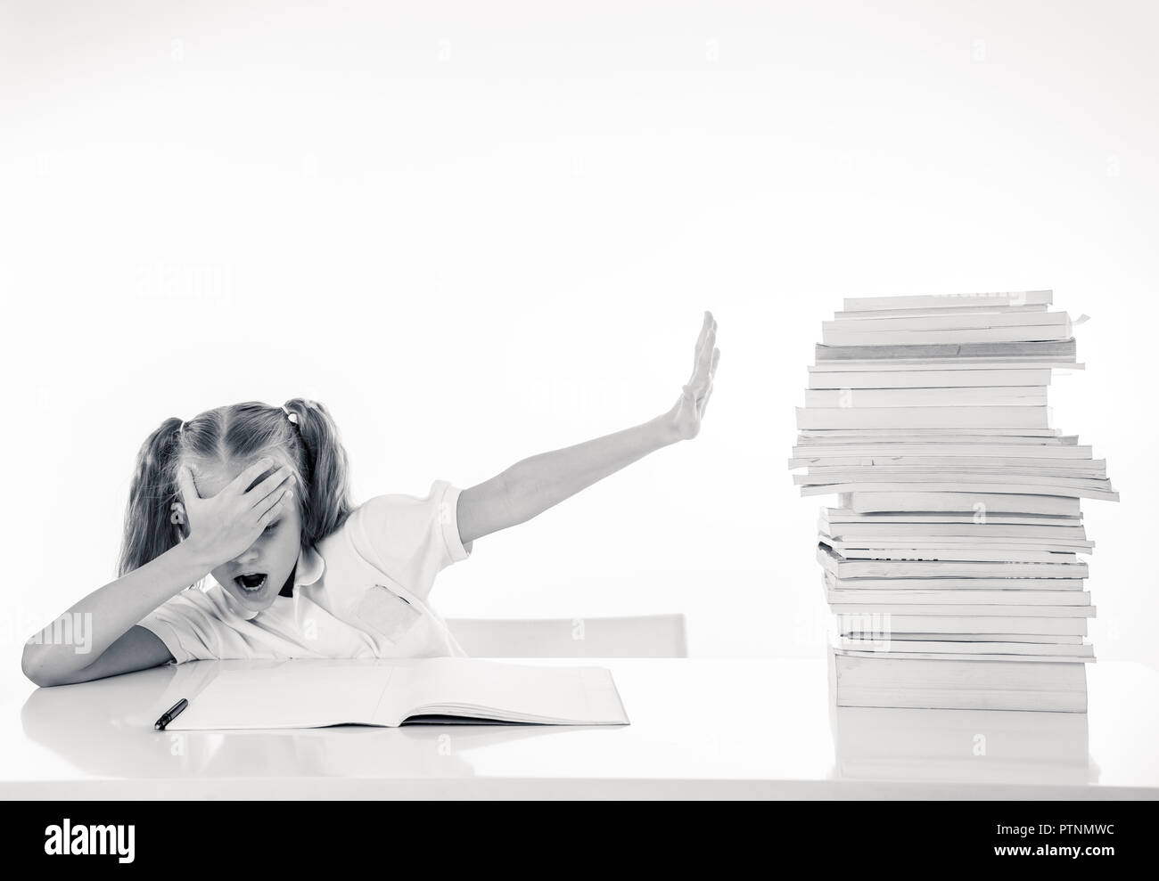 Sad and tired cute schoolgirl with blond hair sitting in stress doing ...