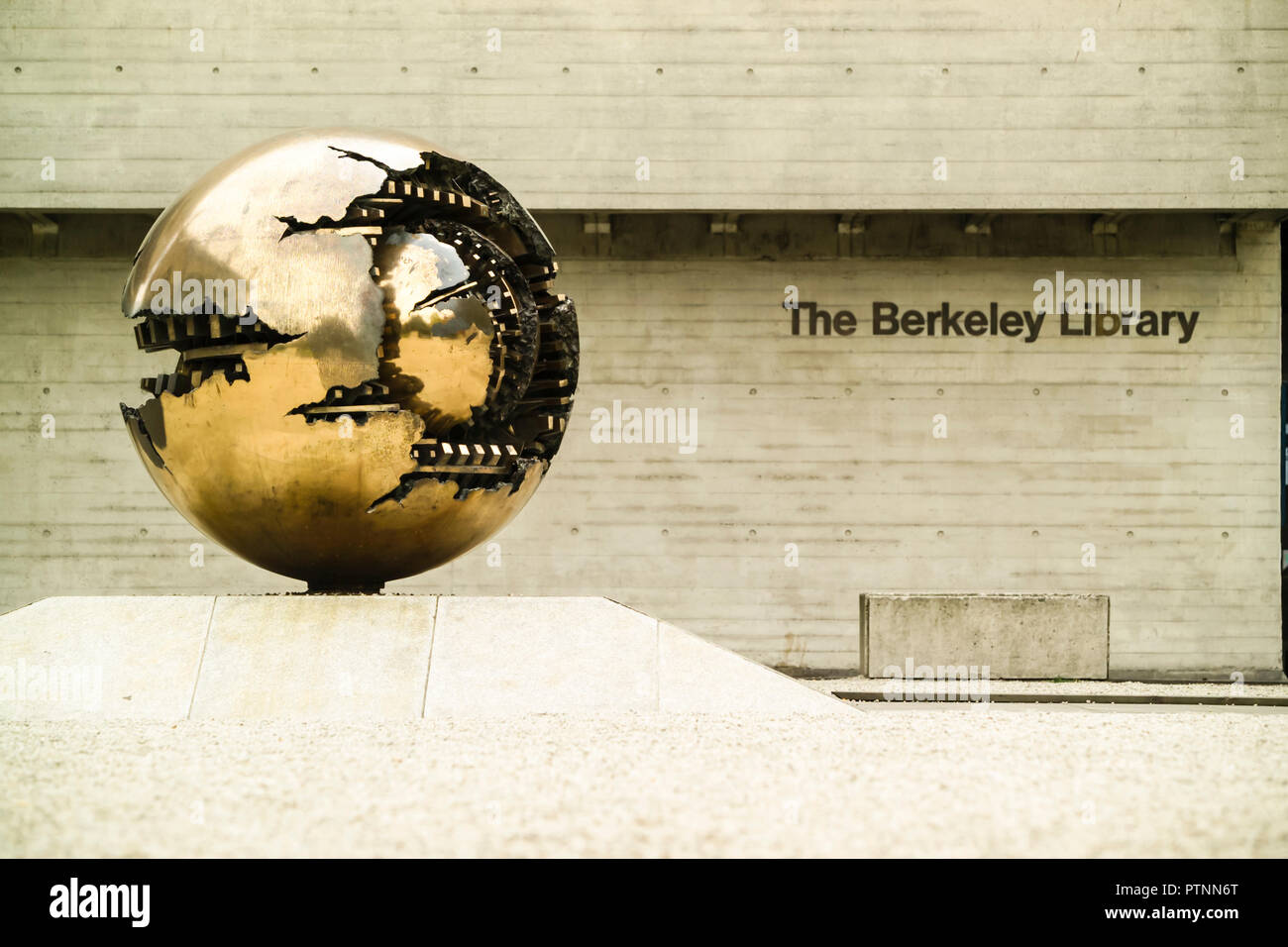 Bronze sculpture 'Sfera con Sfera' (1986) by Arnaldo Pomodoro. In front ...