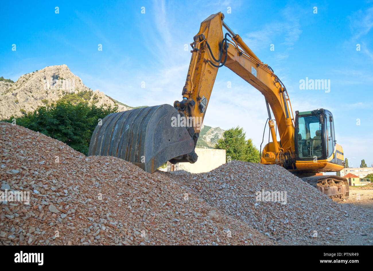 Excavator on construction site Stock Photo - Alamy