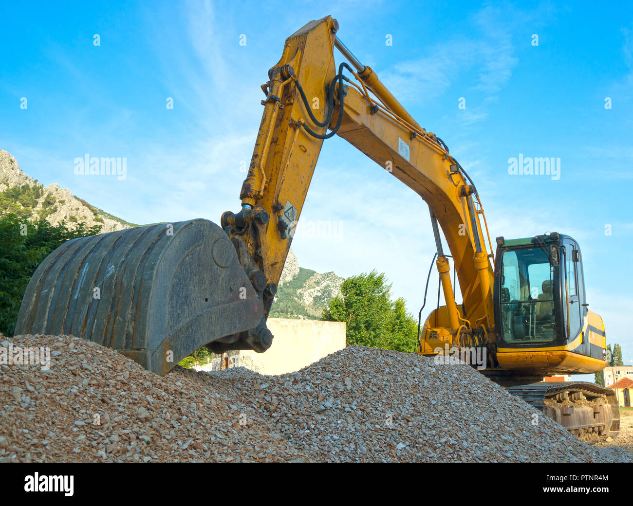 Excavator on construction site Stock Photo - Alamy