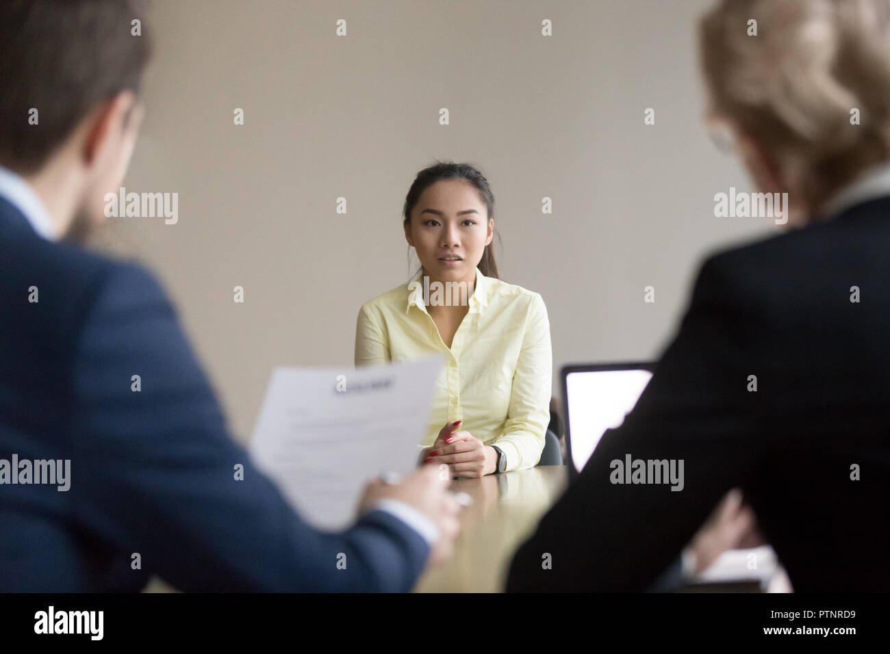 Asian applicant talk during interview with recruiters Stock Photo - Alamy