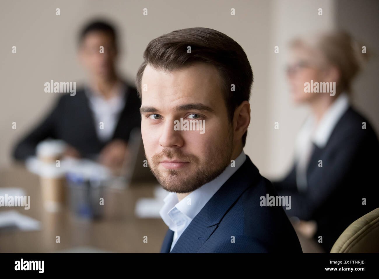Portrait of millennial male employee making picture at meeting Stock ...