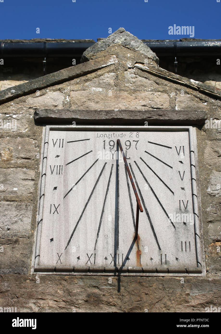 Sundial inscribed with longitude above doorway of entrance porch to ...