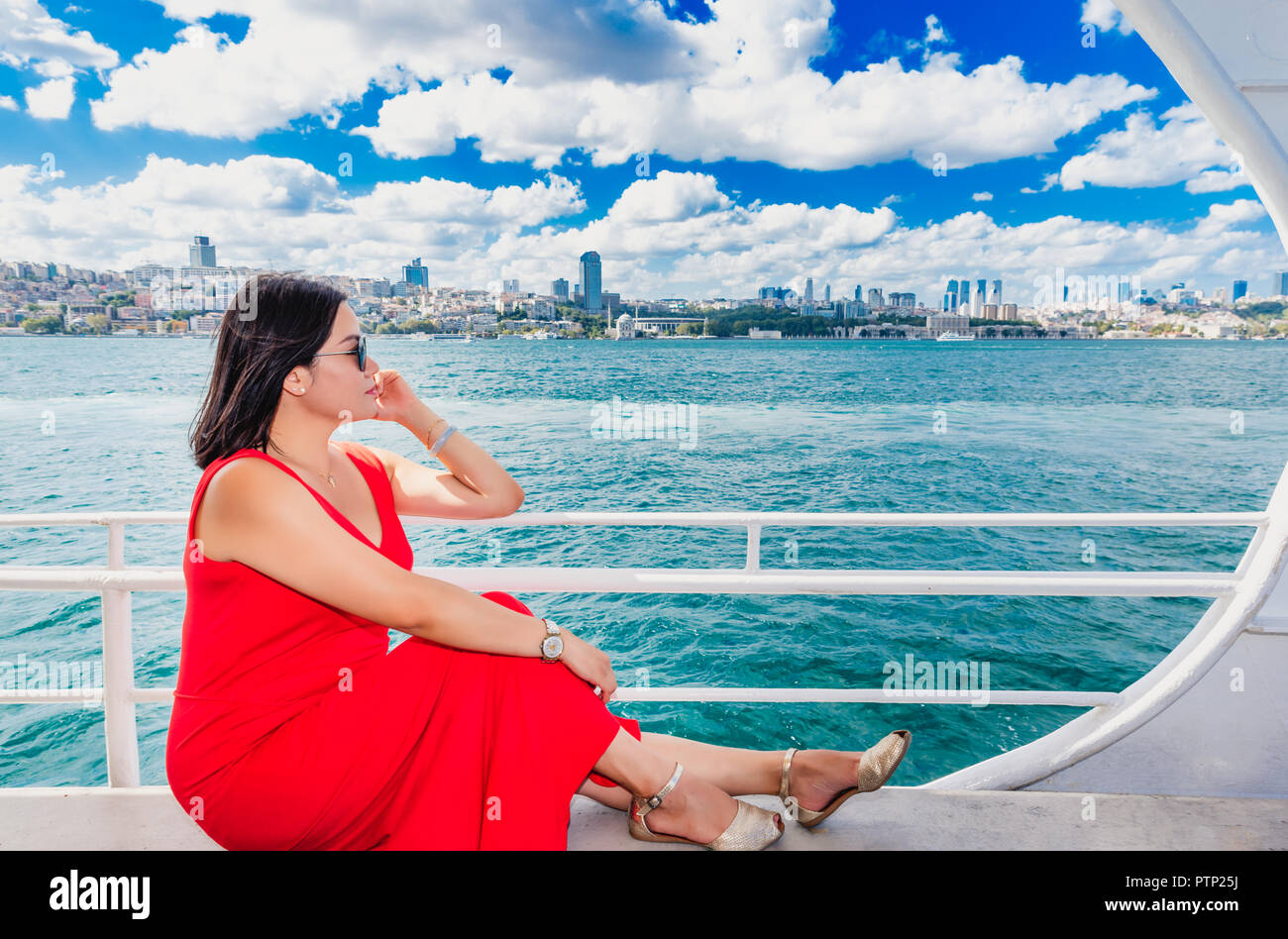 Beautiful Chinese woman cruises in ferry with view of Istanbul ...