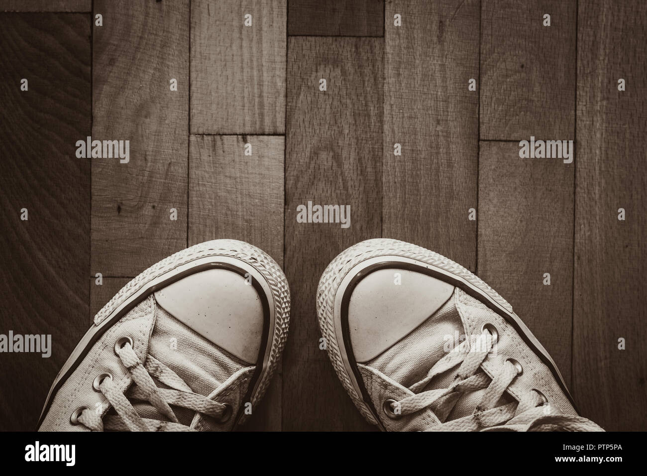 Old shoes on brown wood background Stock Photo - Alamy