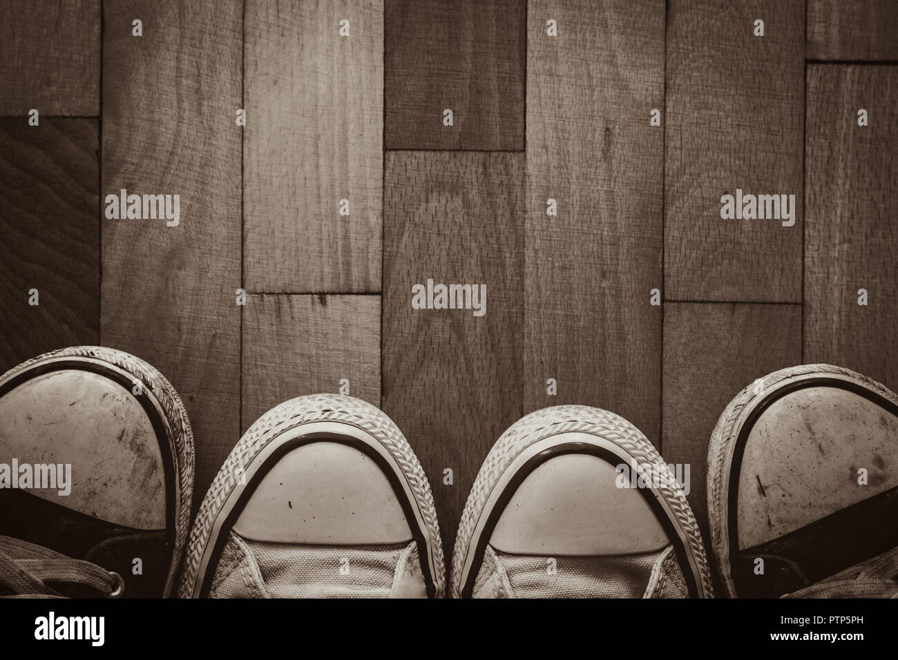 Old shoes on brown wood background Stock Photo - Alamy