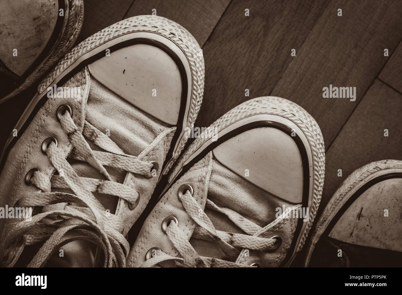 Old shoes on brown wood background Stock Photo - Alamy